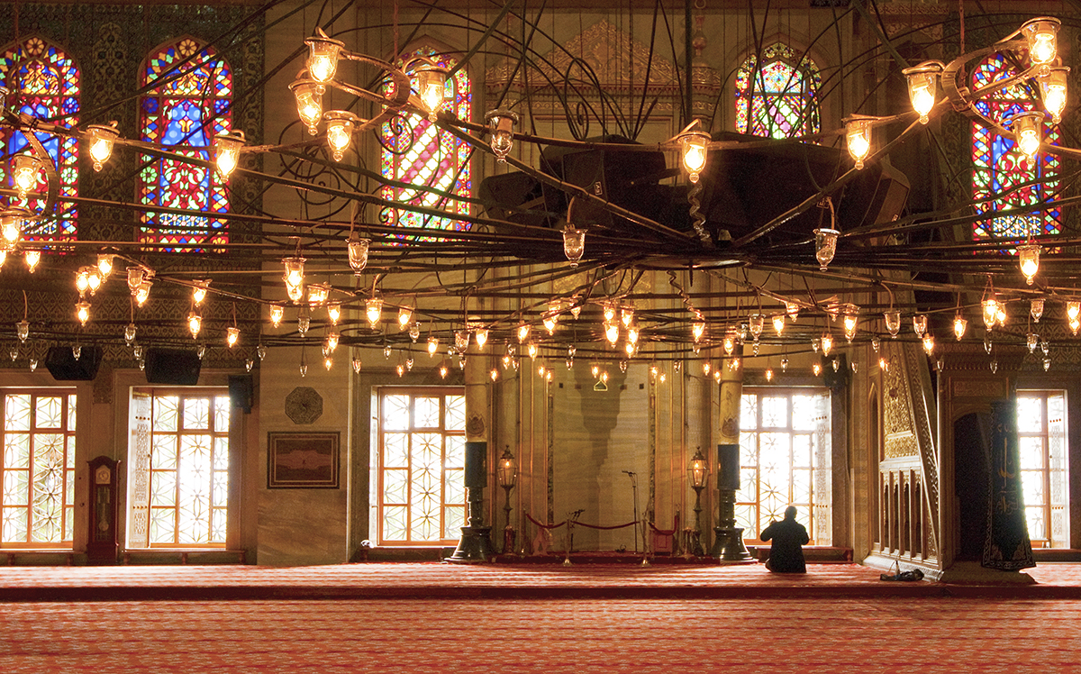 Person praying in Blue Mosque, Istanbul, Turkey • Wander Your Way